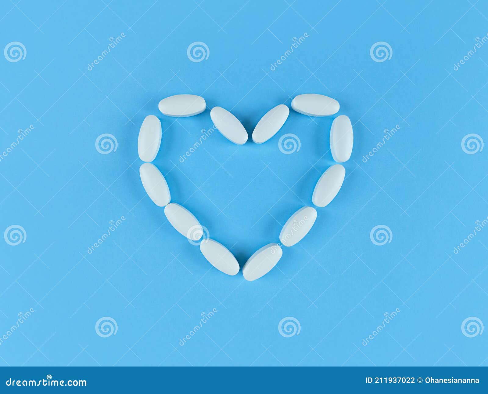 Heart Shape Made from White Tablets on Blue Backdrop Stock Photo ...