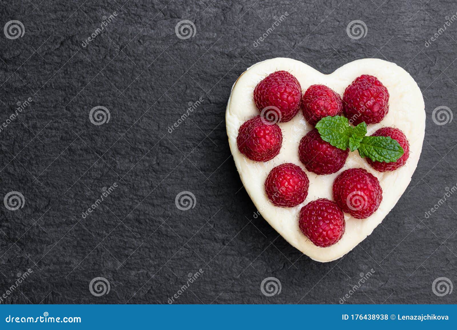 Heart Shaped Cheesecake with Raspberry on Black Stone Background. Top ...