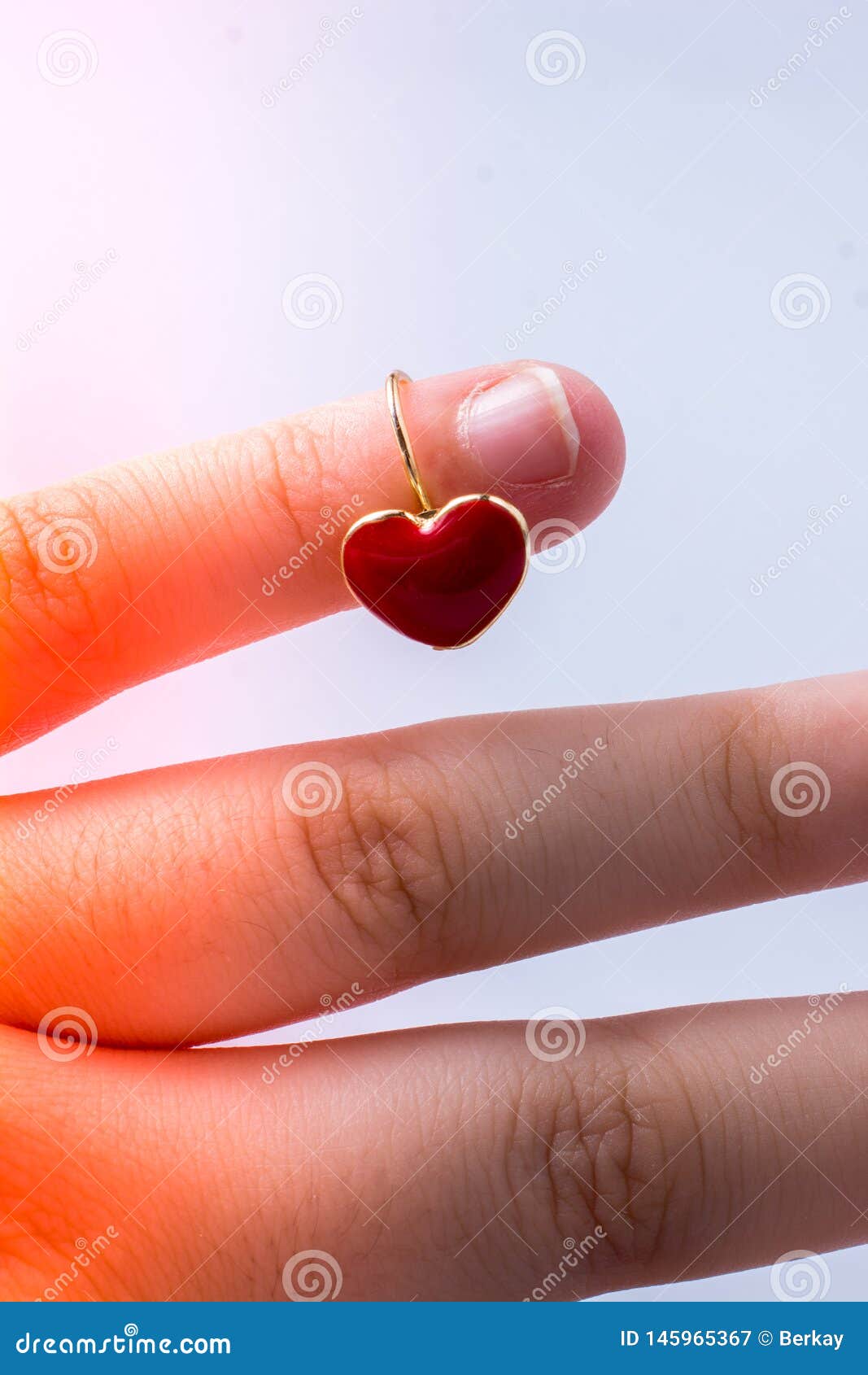 Heart Shaped Earring in Hand on White Stock Image - Image of ...