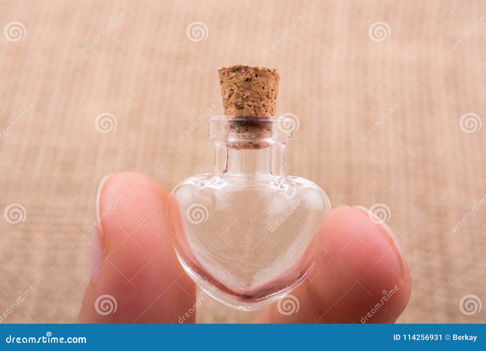 Heart Shaped Glass Bottle in Hand Stock Image - Image of love, bottles ...