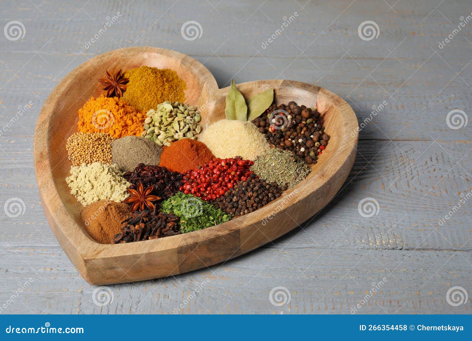 Heart Shaped Plate with Different Spices on Grey Wooden Table Stock ...