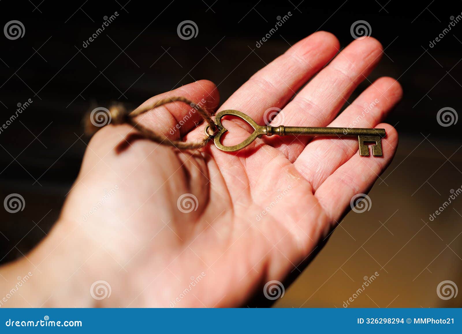 Heart Shaped Vintage Skeleton Key in Hand on Dark Background Stock ...