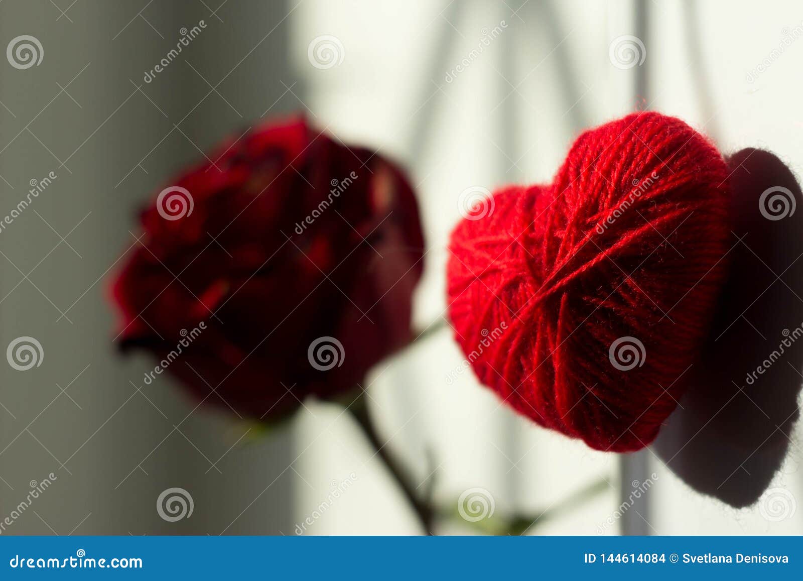 Heart of Threads Yarn on a Background of Red Roses Stock Photo - Image ...