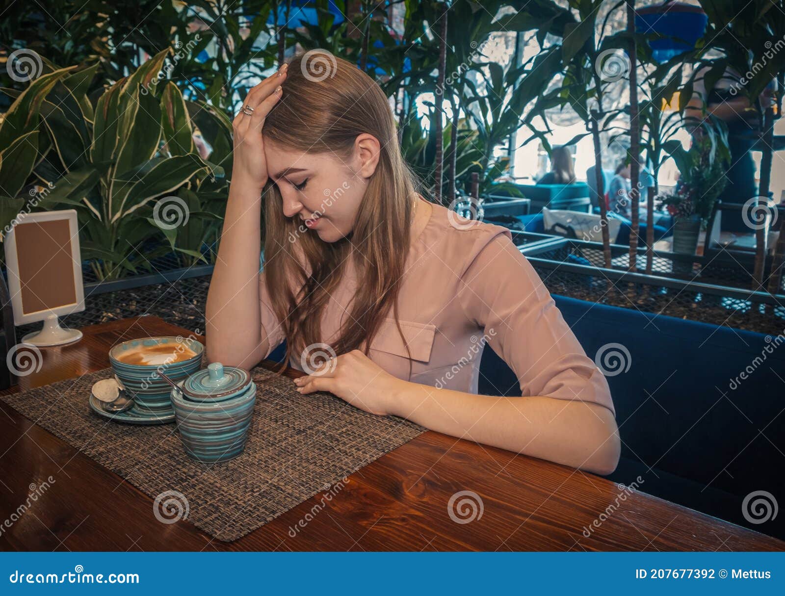 A Heartbroken Young Asian Woman Looks Regretfully On A Separated Heart ...