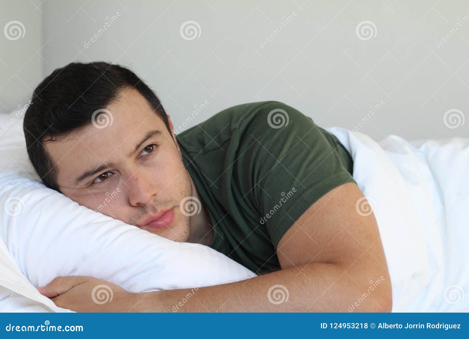 Heartbroken Young Man Laying Down in Bed Stock Photo - Image of ...