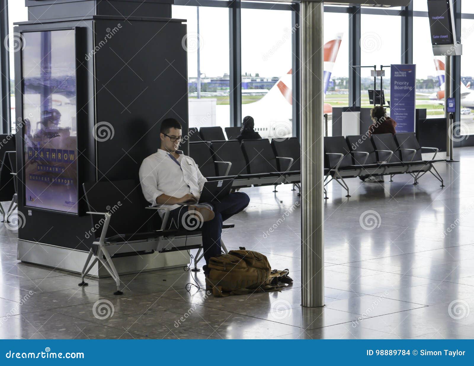 Heathrow Airport - Man Working on His Laptop Editorial Stock Image ...