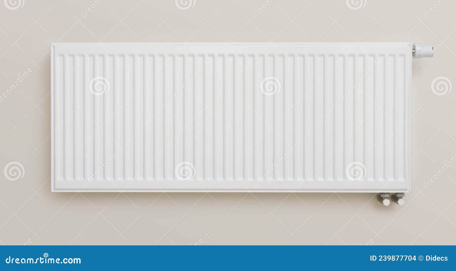 Heating Radiator with Adjusting Knob Installed on Beige Color Wall ...