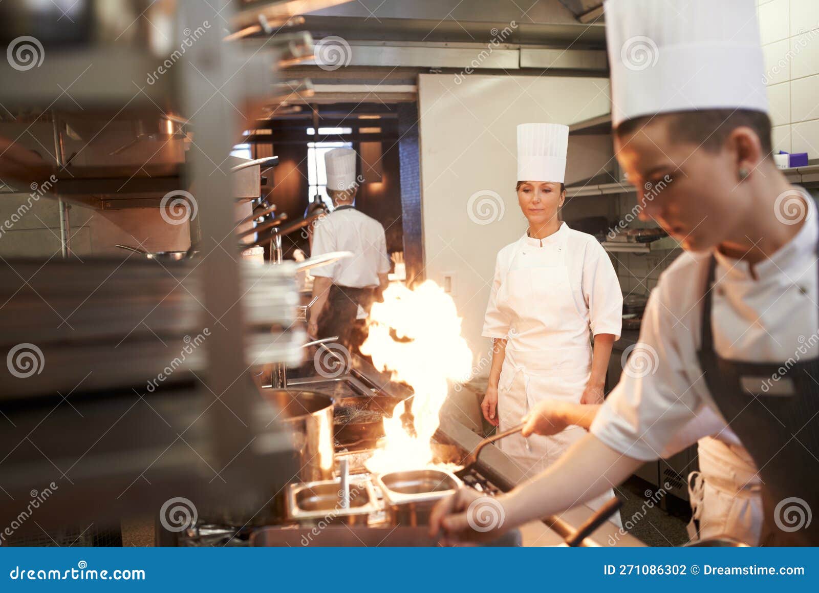 Heating Up the Kitchen. Chefs Preparing a Meal Service in a ...