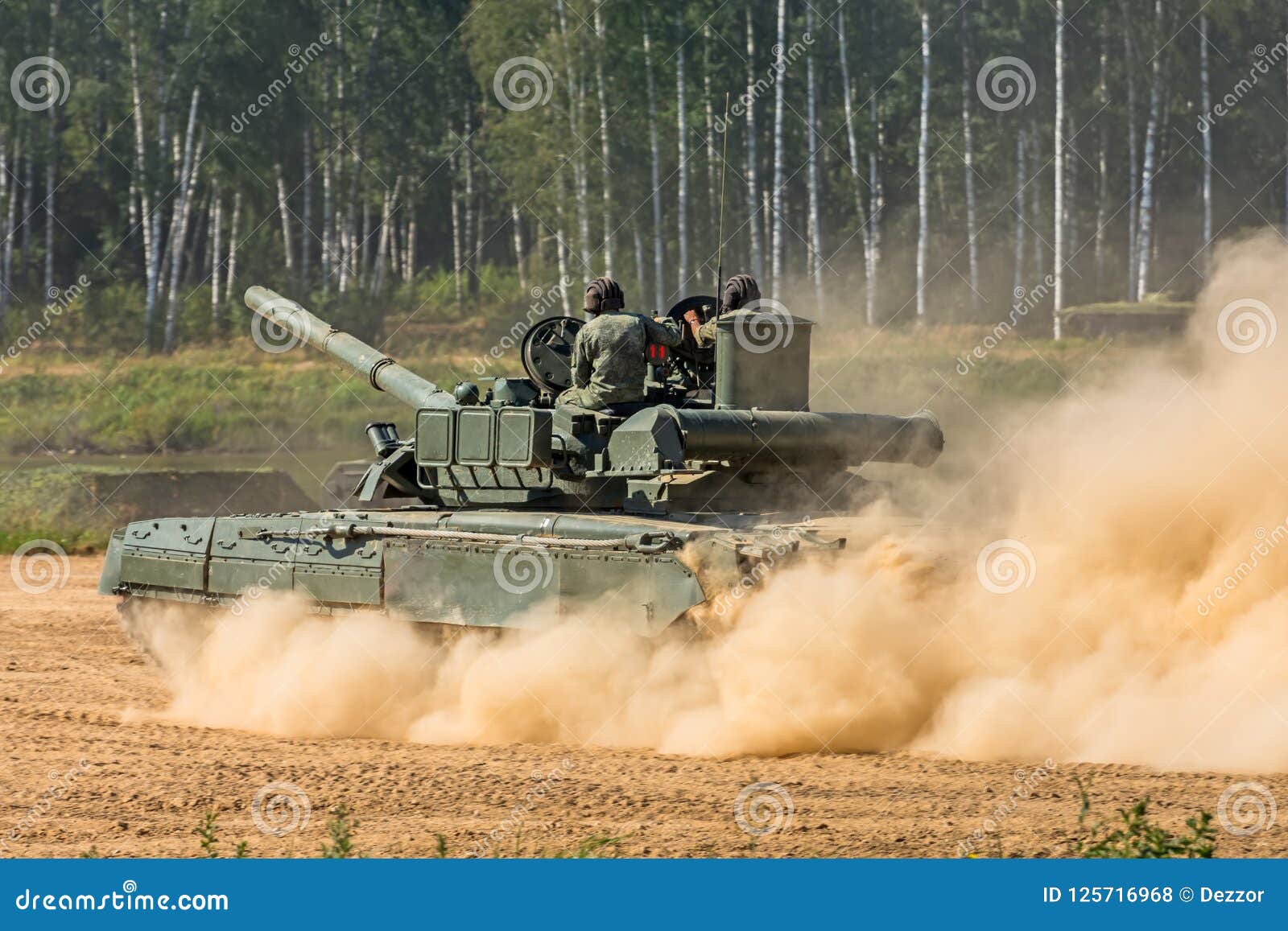 Heavy Armor Tank with Dust from Under the Caterpillars in the Field of ...