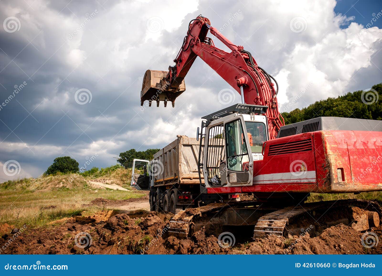Heavy Bulldozer and Excavator Loading and Moving Red Sand Stock Photo ...