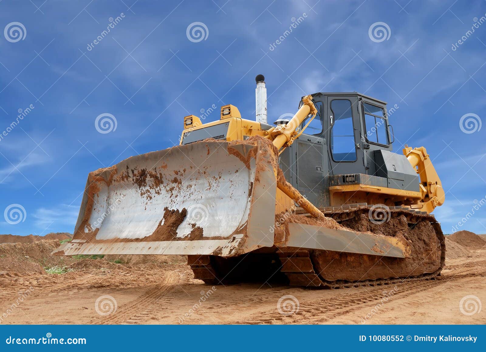 Bulldozer With Raised Hydraulic Boom And The Bucket Full Of Earth ...