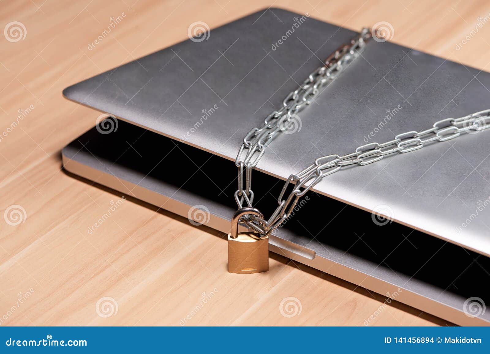 Heavy Chain with a Padlock Around a Laptop on Table Stock Photo - Image ...