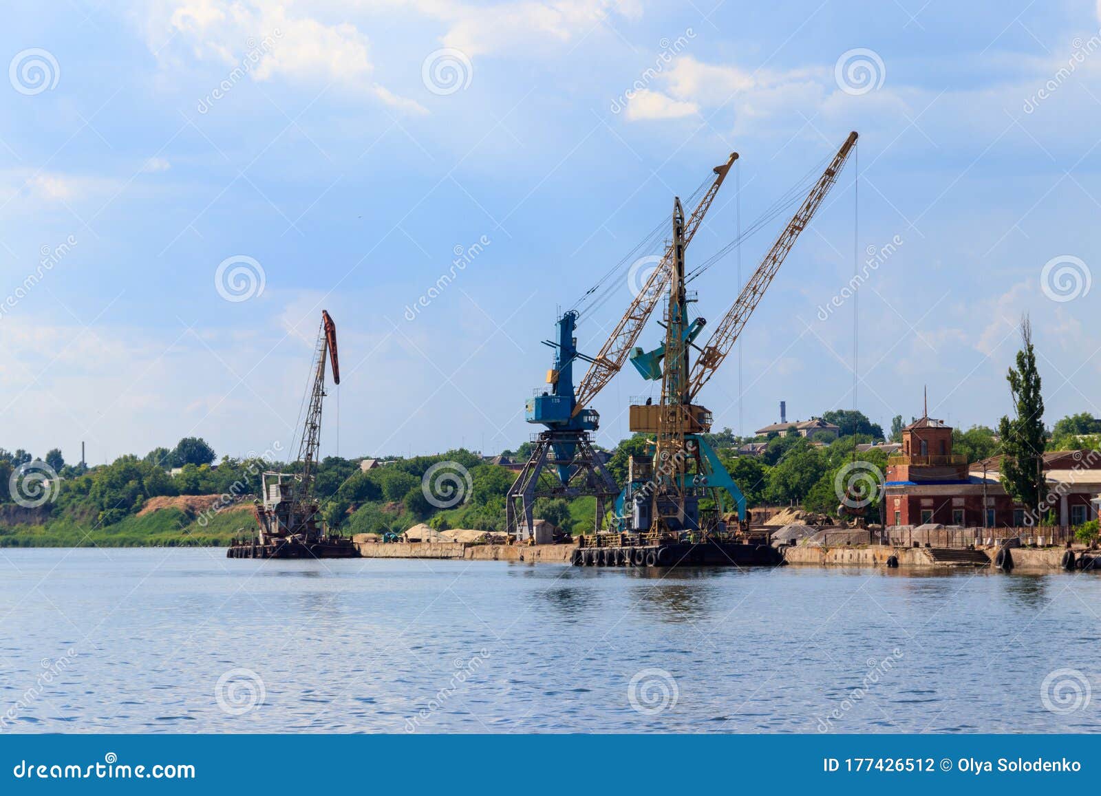 Heavy Cranes in Cargo Port on Riverbank Stock Photo - Image of cloud ...