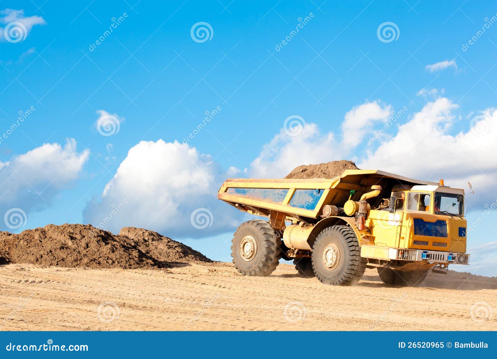 Heavy Dump Trucks And Hydraulic Luffing Jib Tower Cranes Works At A ...