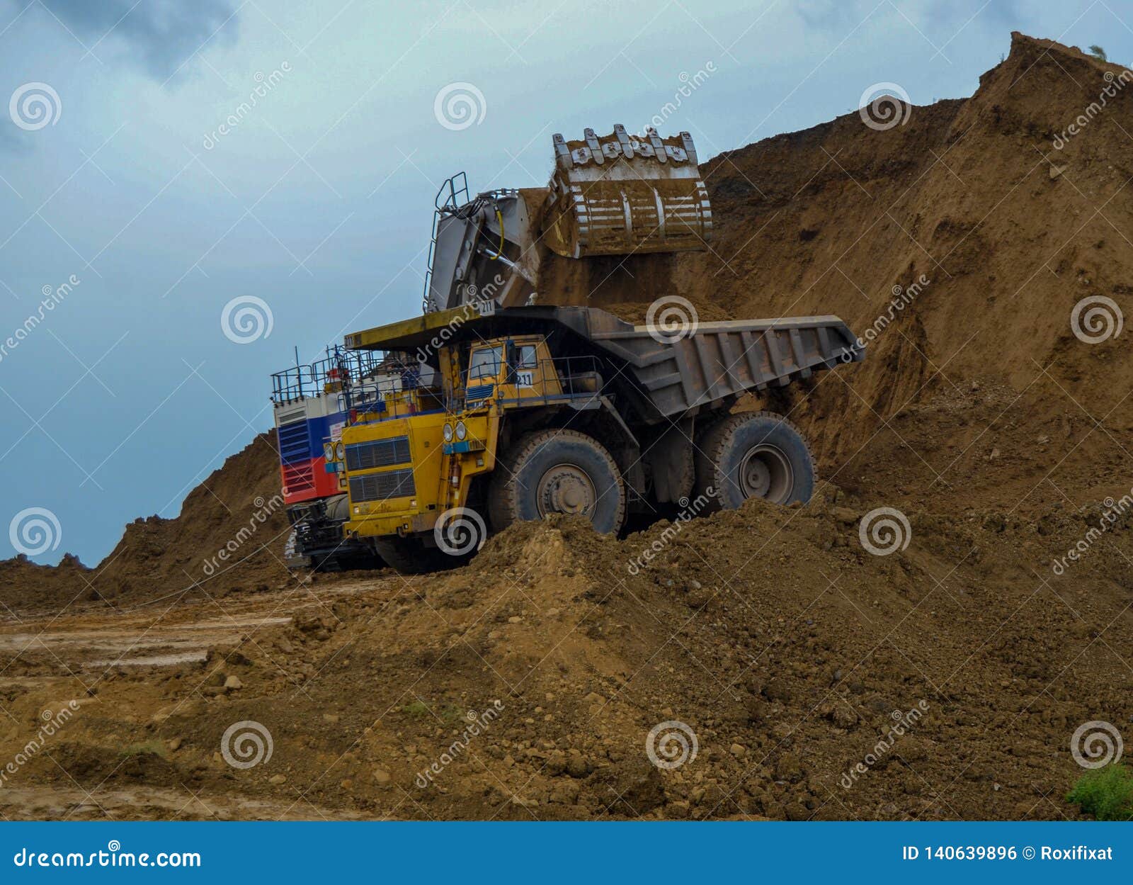 Heavy dump truck at work stock photo. Image of digger - 140639896