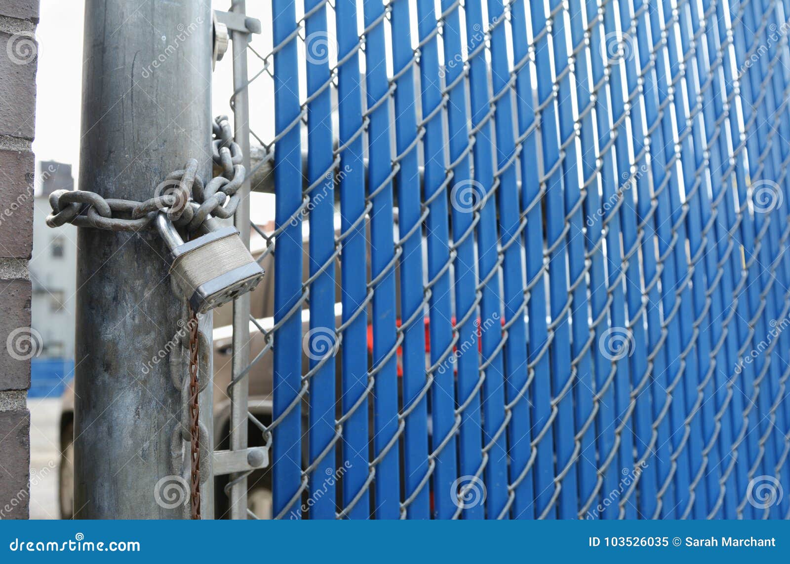 Heavy-duty Padlock and Chain on Blue Security Gate Stock Image - Image ...