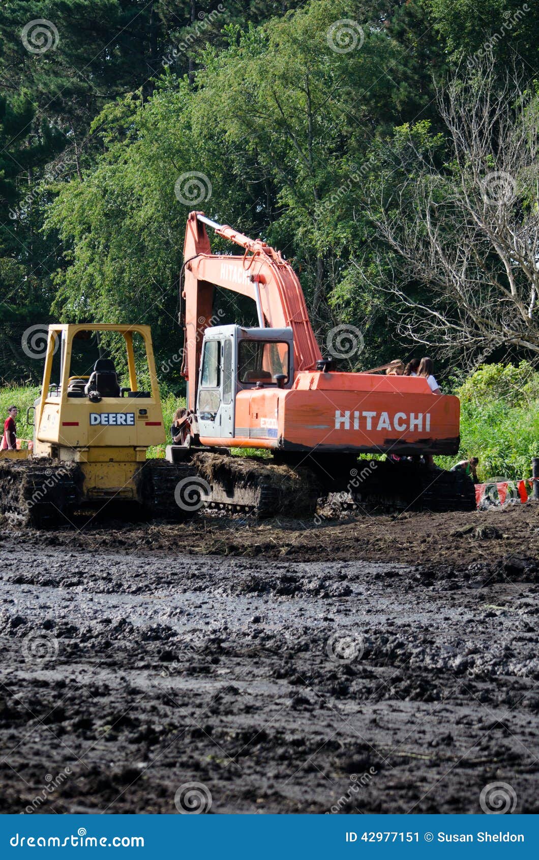 Heavy Equipment on a Muddy Work Site Editorial Photo - Image of front ...