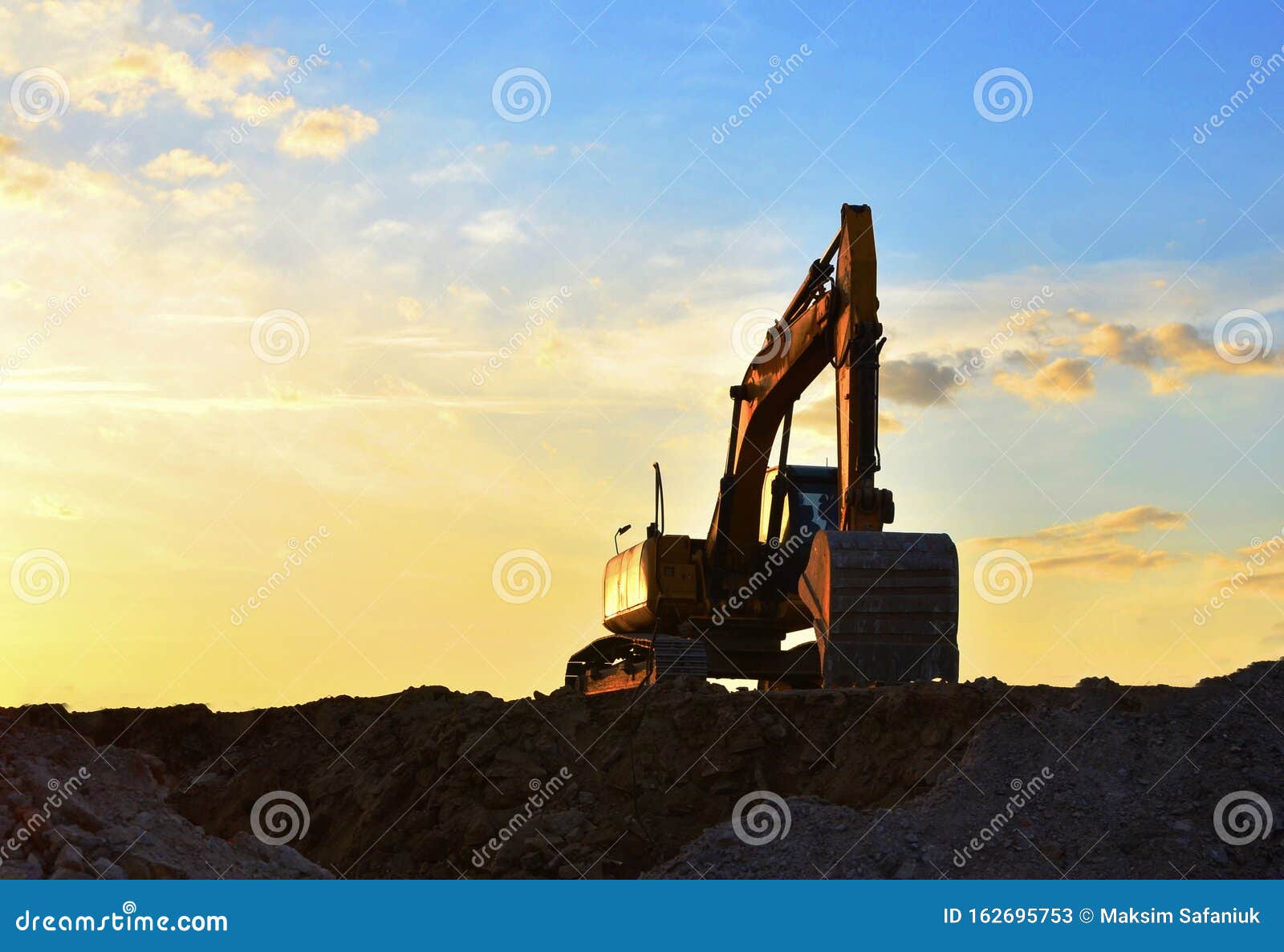 Heavy Excavator Working at Construction Site on a Background Sunset ...