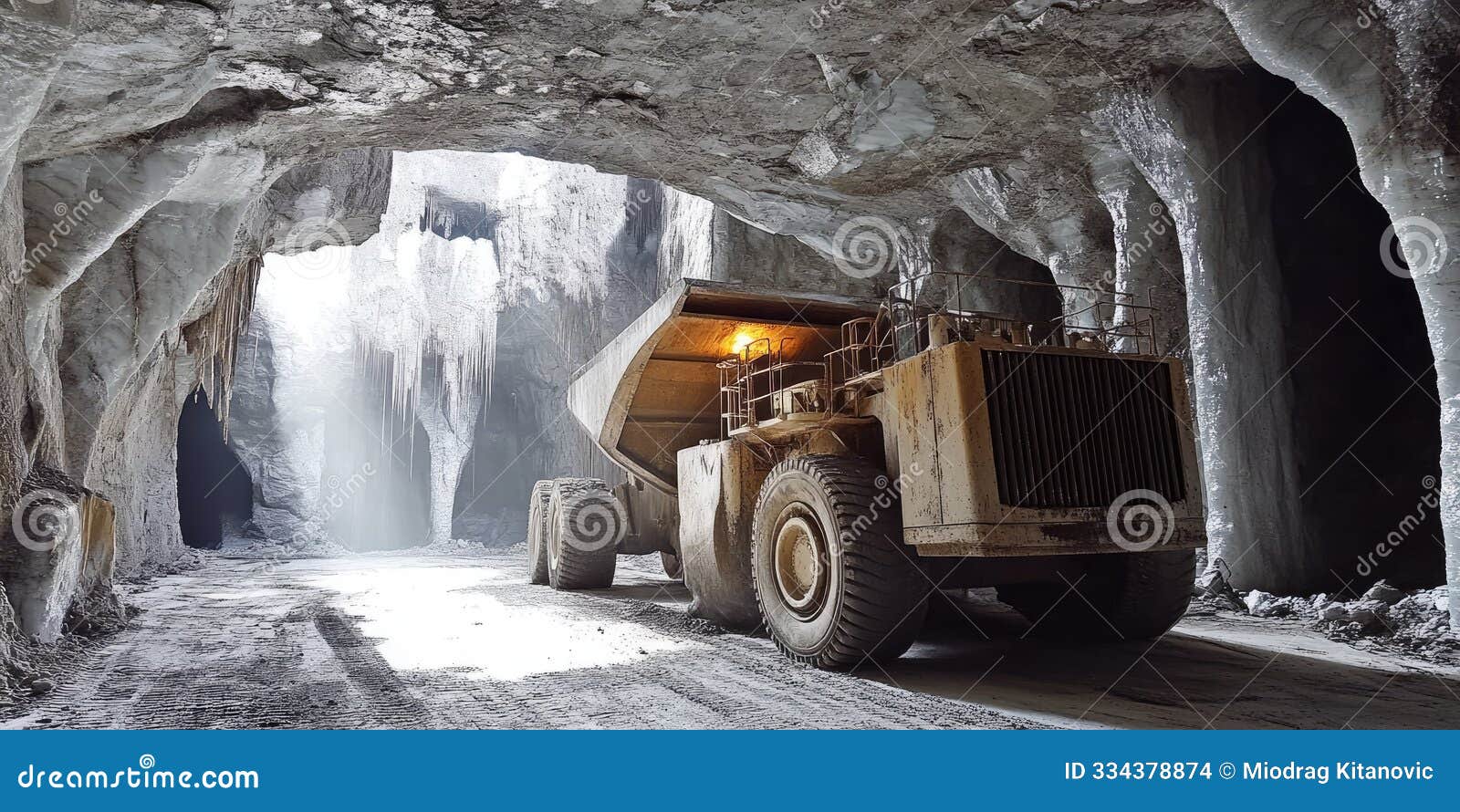 Heavy Mining Truck Operating in an Icy Underground Cave during Daylight ...
