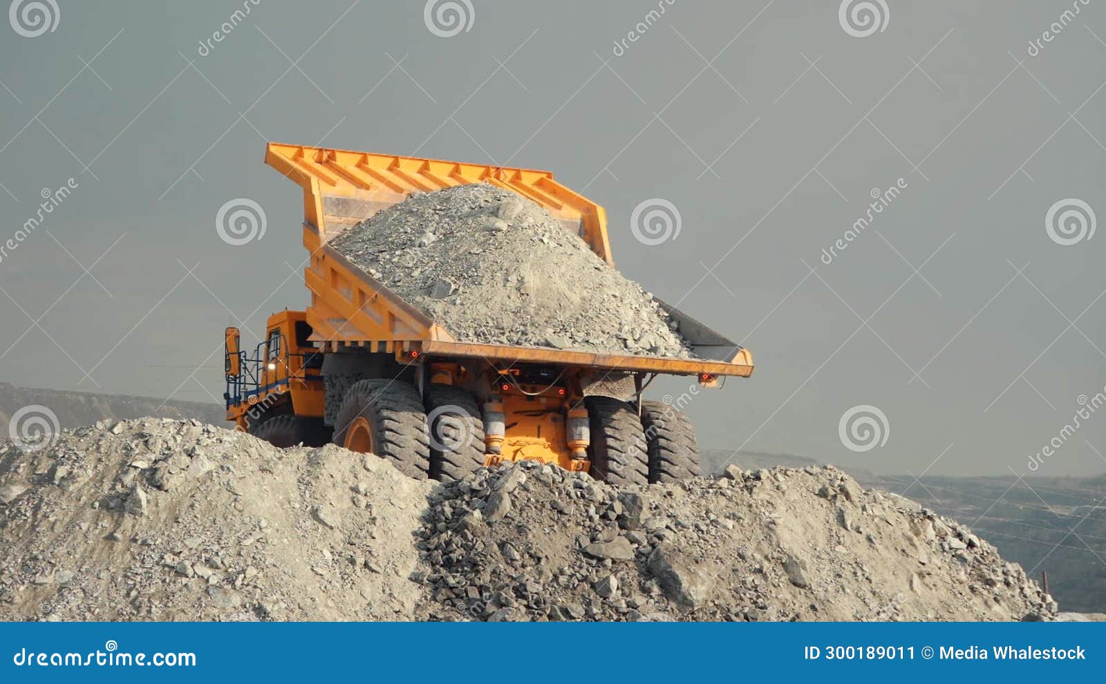 Heavy Mining Truck Unloads the Ore in a Quarry. Mining Industry. Stock ...