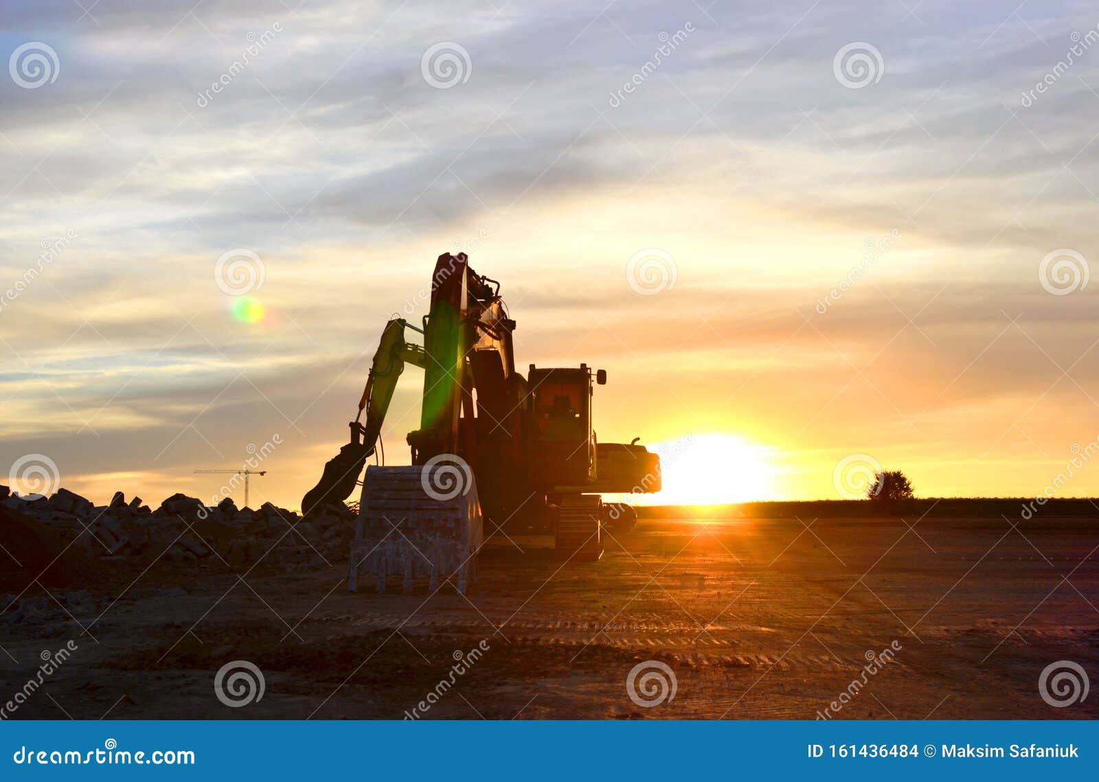 Heavy Tracked Excavators at a Construction Site on a Background Sunset ...