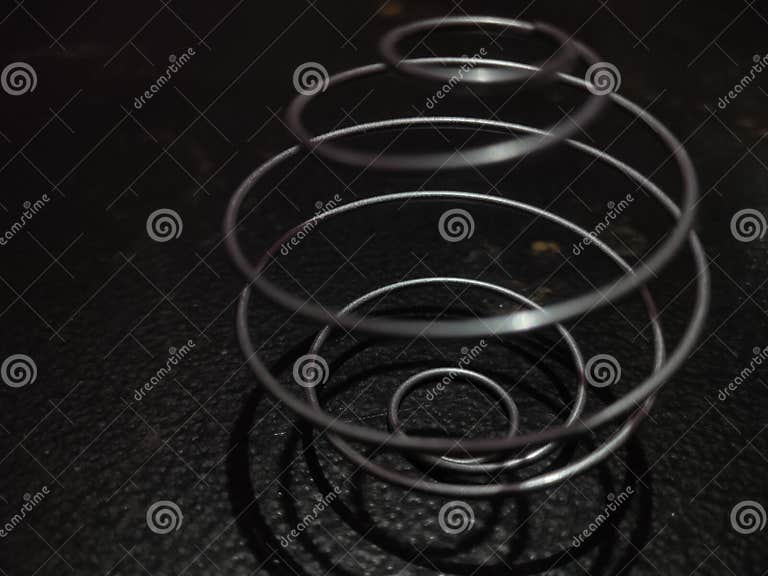 Helical spring shaker dark stock photo. Image of lighting - 245993094