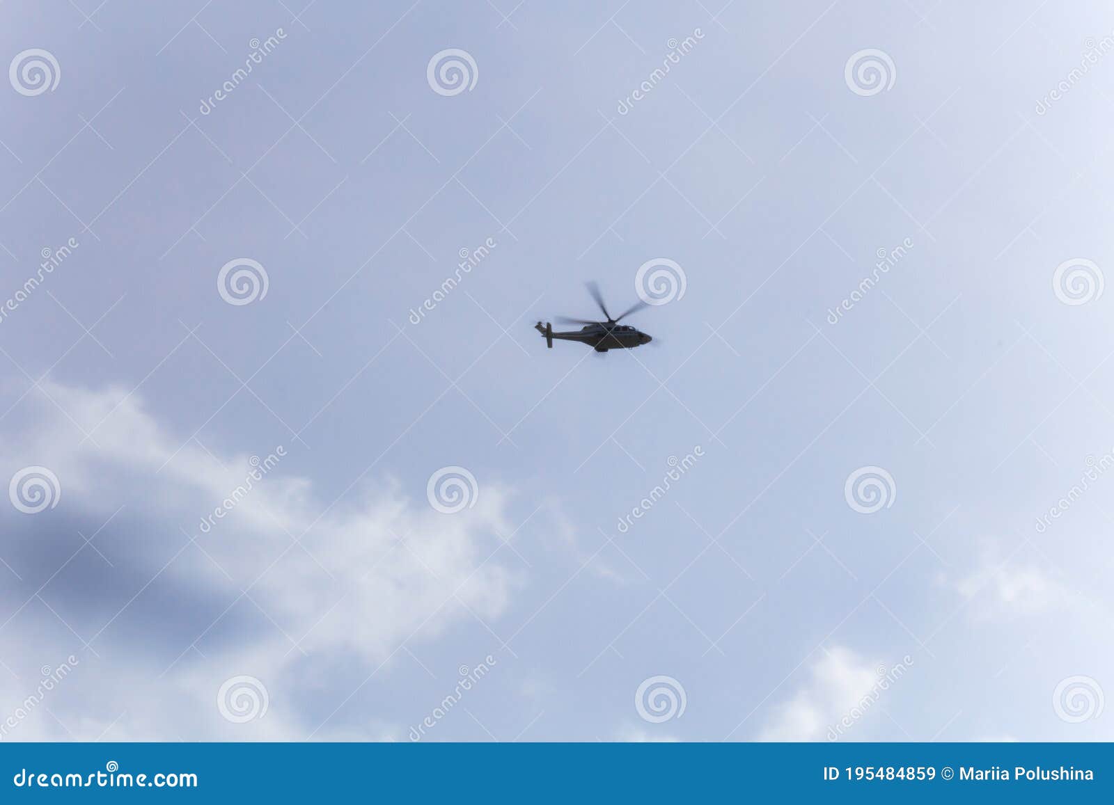 Helicopter in the Distance in Light Sky with Cloud. Soft Focus ...