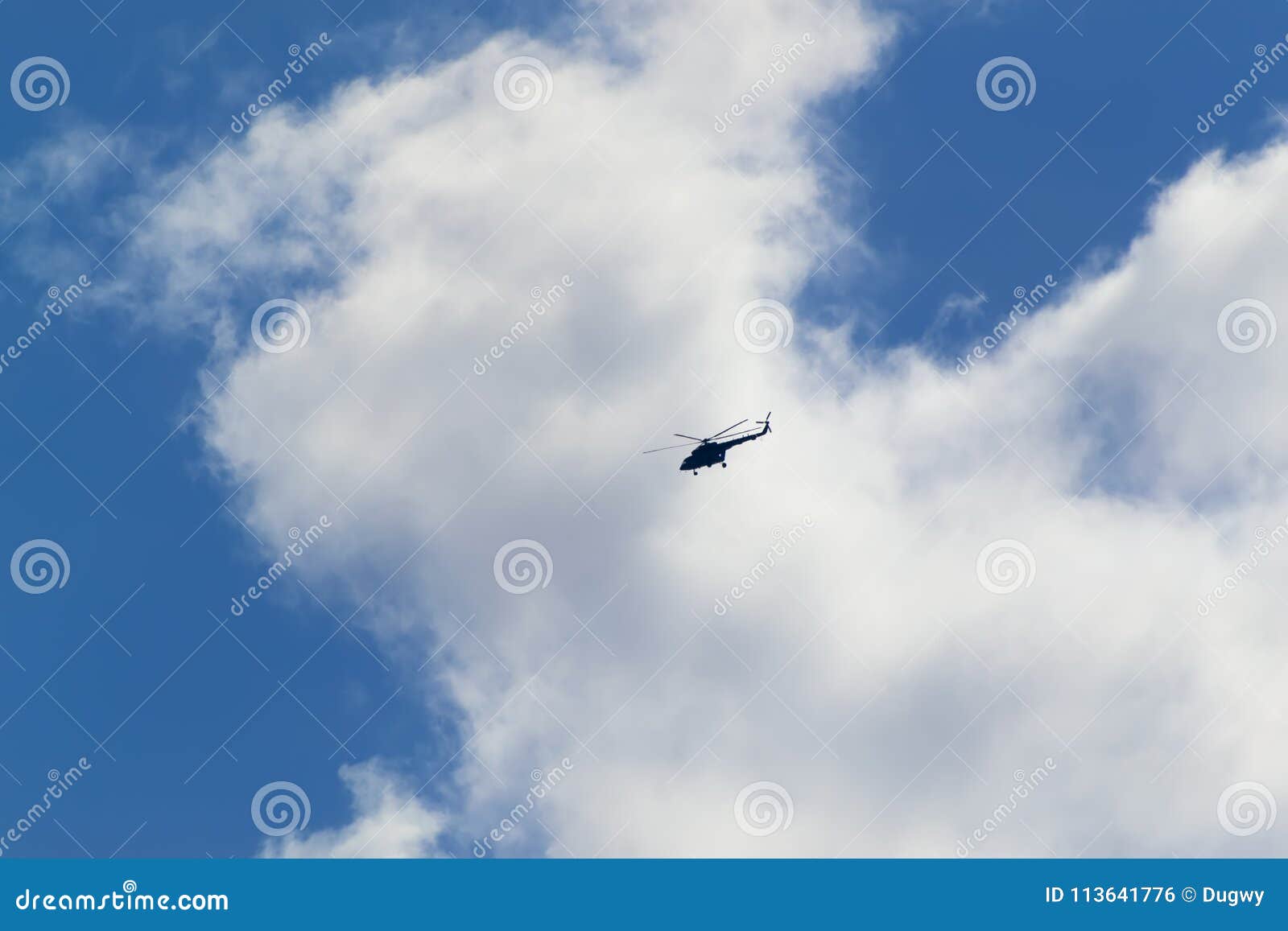 A Helicopter Flies High in the Sky Stock Photo - Image of helicopter ...