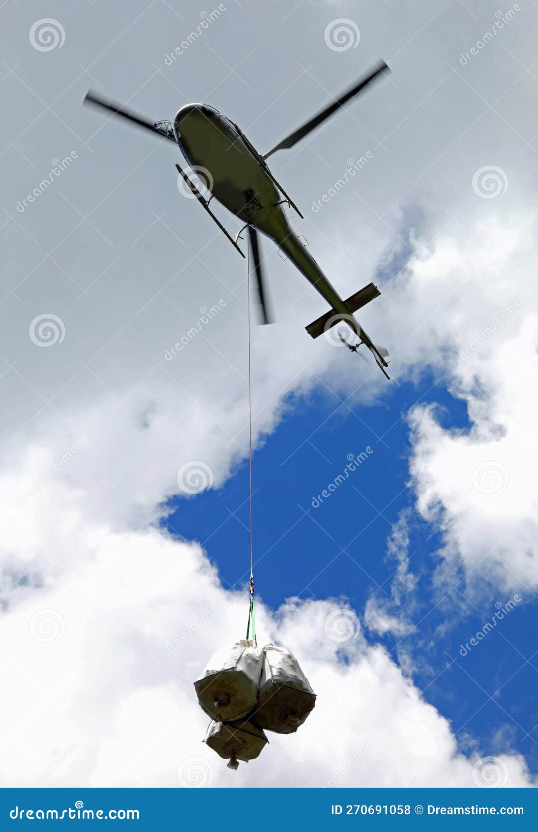 Helicopter in Flight while Transporting the Goods Attached To the Winch ...