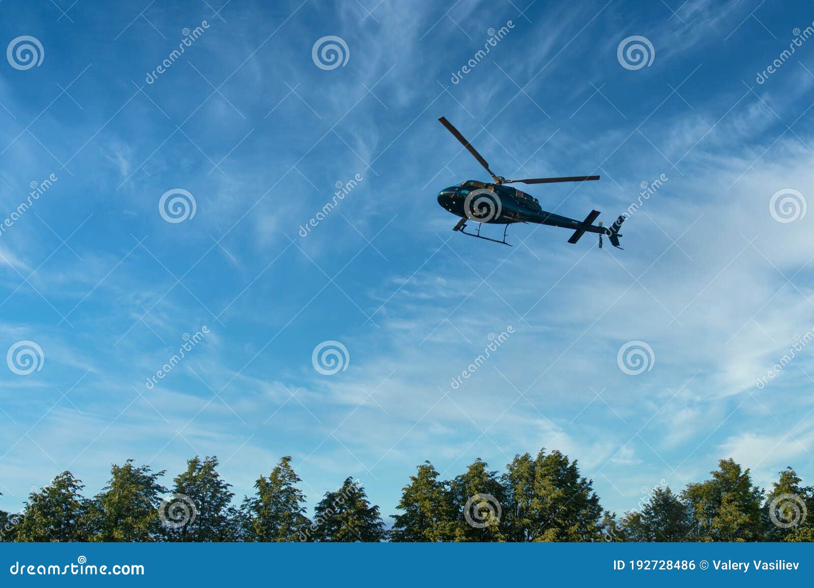 Helicopter Flying Over the Forest in the Sky with Clouds Stock Photo ...