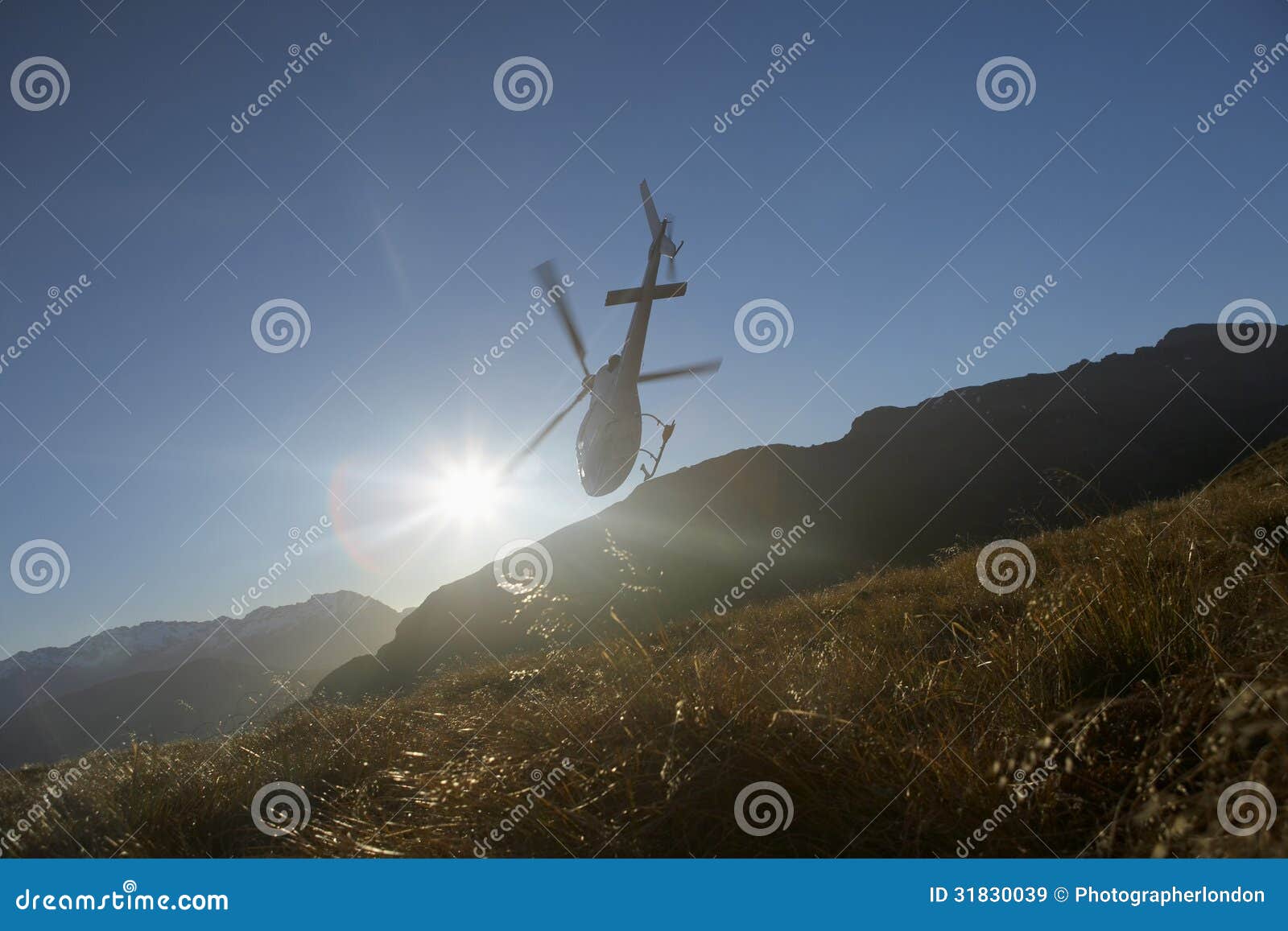 Helicopter Flying Over Hills in Front of the Sun Stock Image - Image of ...