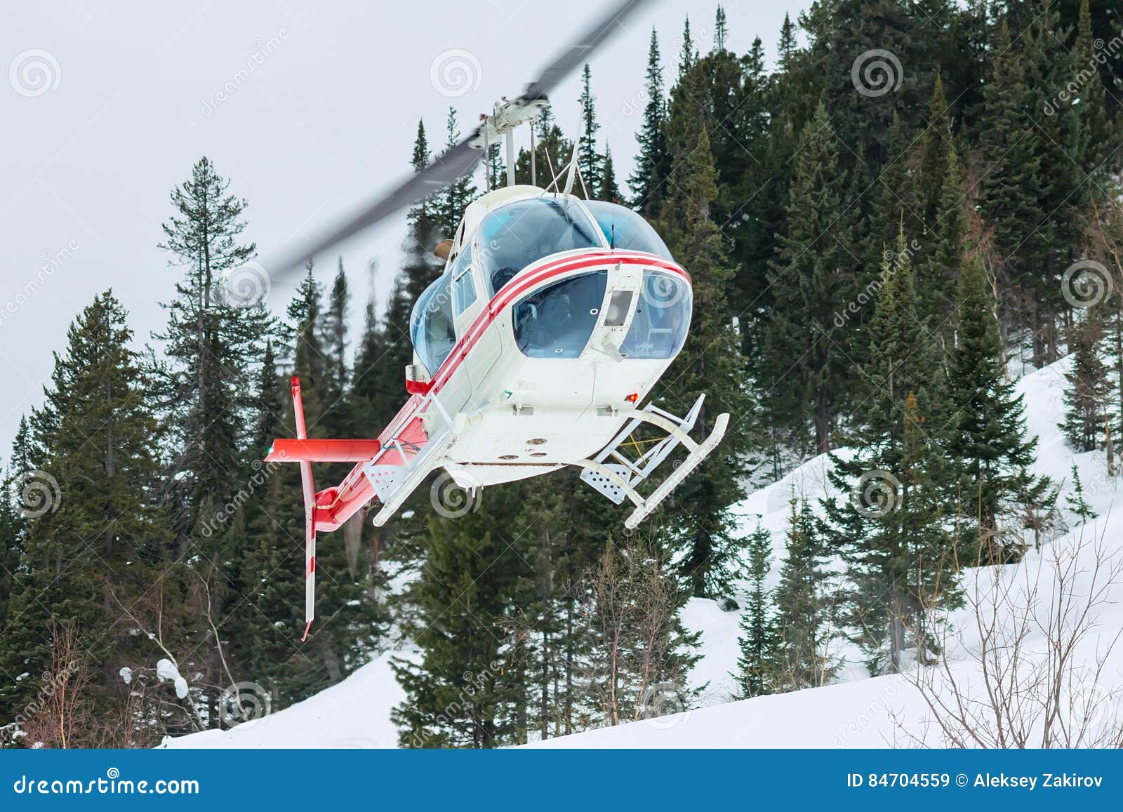 The Helicopter Landed in the Mountains in Winter, Raising a Cloud of ...