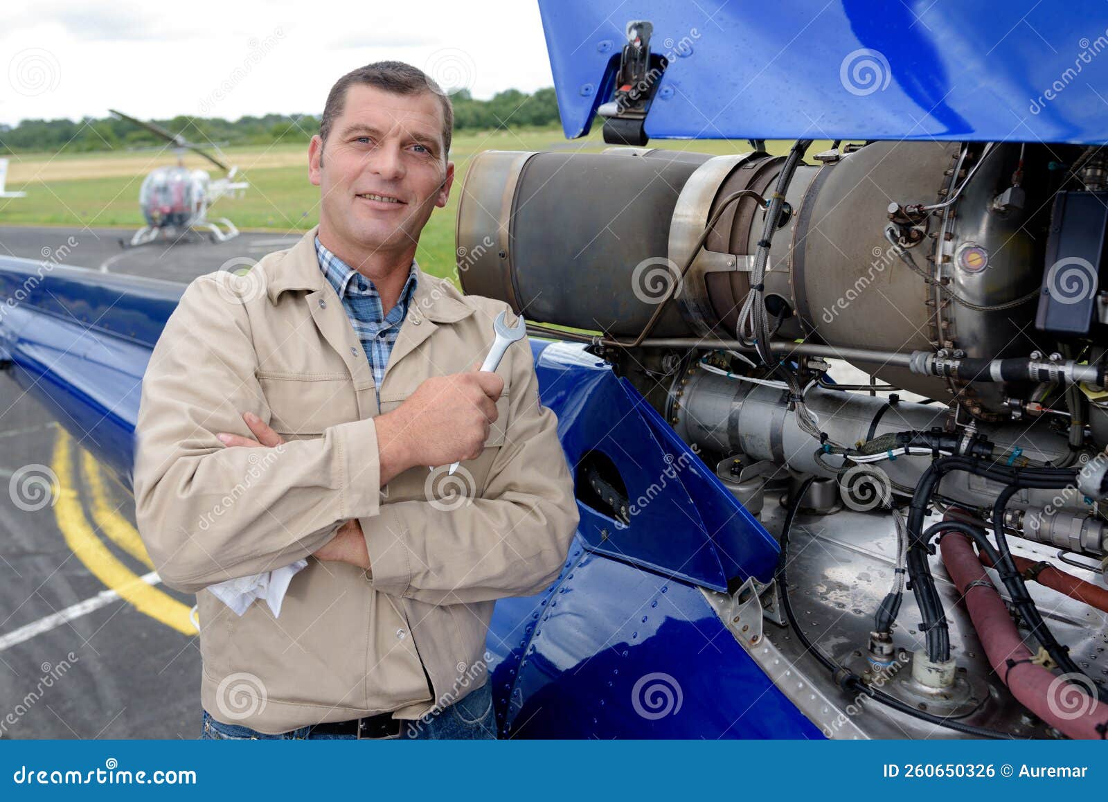 Helicopter Mechanic Posing Holding Wrench Stock Photo - Image of salary ...