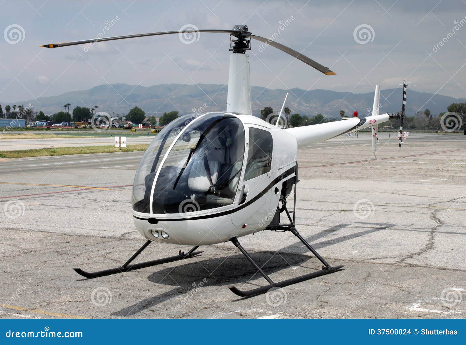 Helicopter parked on ramp stock photo. Image of robin - 37500024