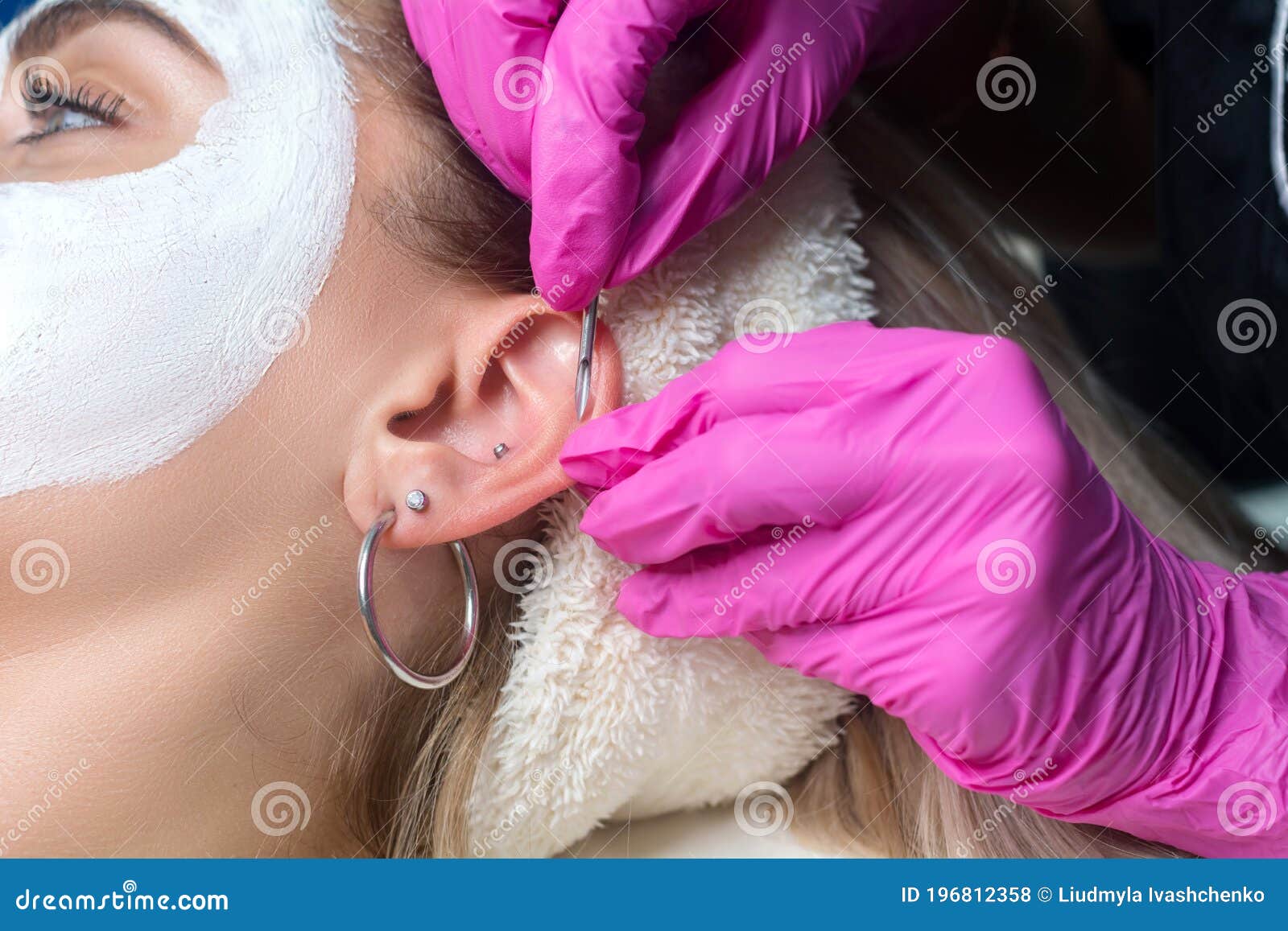 Helix Piercing. Ear Piercing Procedure in the Salon Stock Photo - Image ...