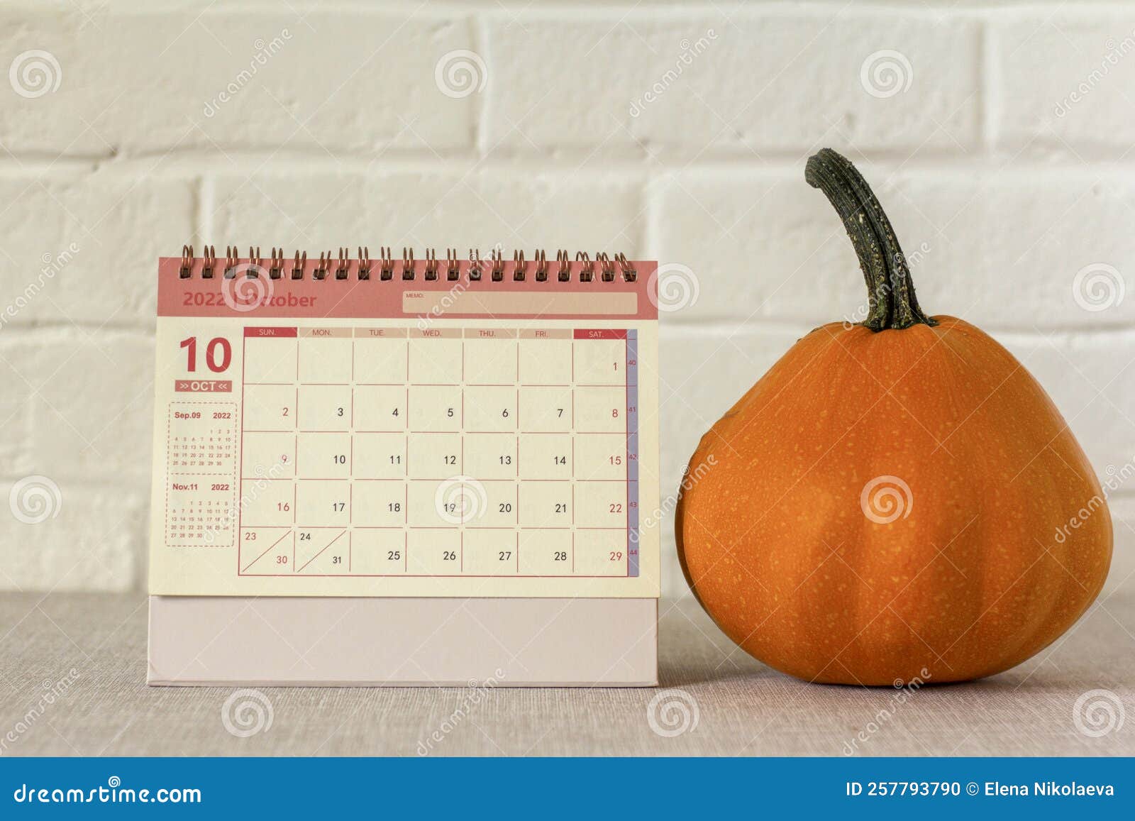 Hello, October.Desktop Calendar for October 2022 on the Table Next To ...
