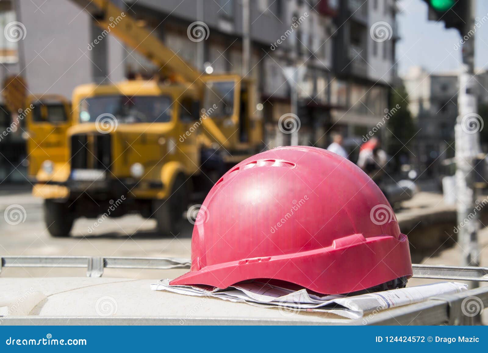 The Helmet on the Construction Plans and Buildings in the Background ...