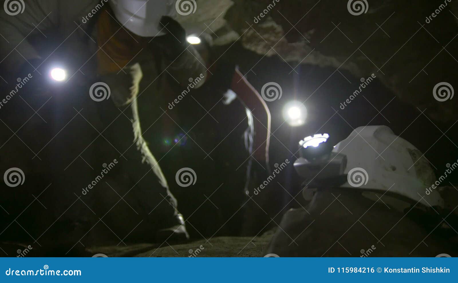 Helmet with Flashlight in Front of Speleologists Explores into the Dark ...
