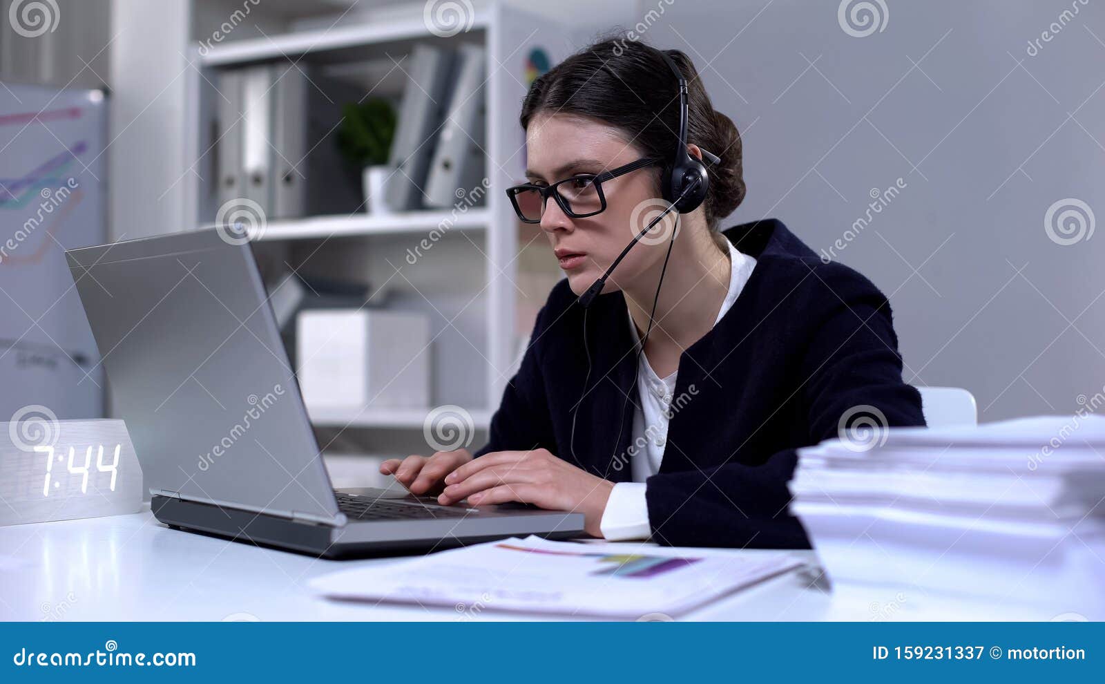 Help Desk Worker in Headset Calling Client Using Laptop, Online ...
