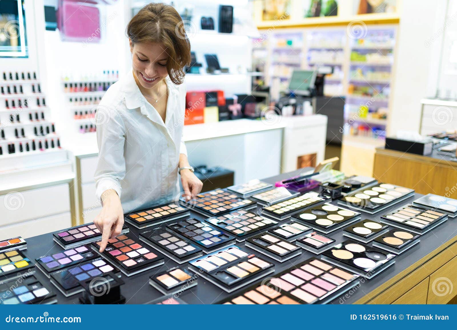 Helpful Assistant at Cosmetics Shop Points Out To Shadow Colour Stock ...