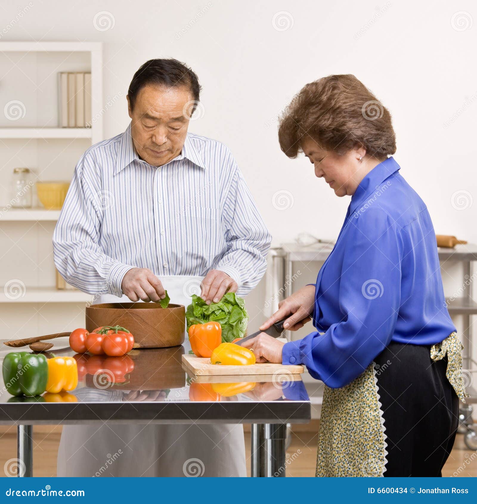 Helpful Man Preparing Salad with Wife in Kitchen Stock Photo - Image of ...
