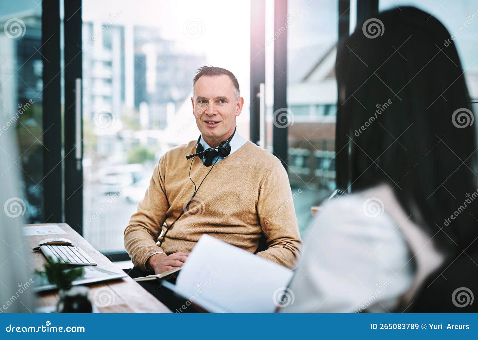 Helping Each Other Help the Customers. Two Call Center Agents Talking ...