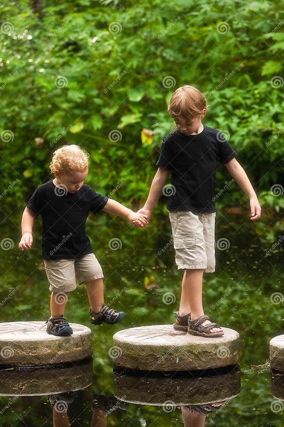 Helping Hands stock photo. Image of stones, hand, sibling - 20924262