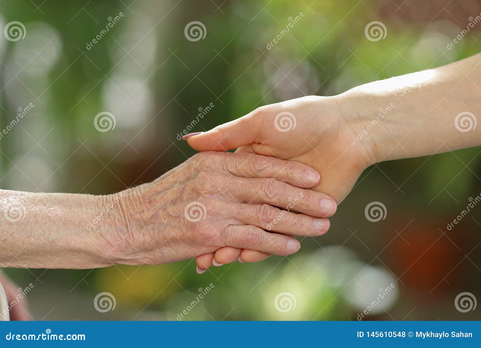 Young Caregiver Holding Seniors Hands. Helping Hands, Care for the ...
