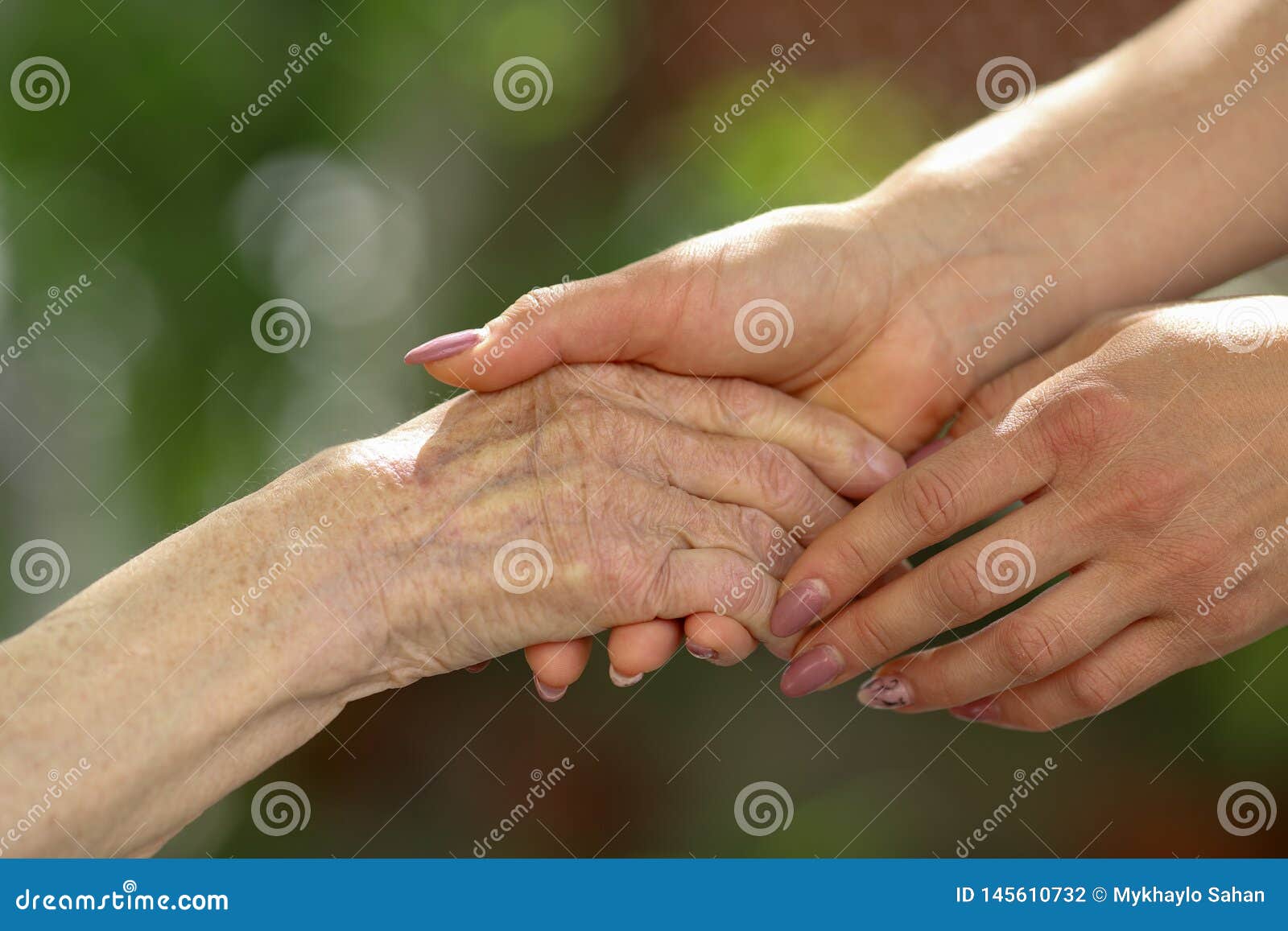Young Caregiver Holding Seniors Hands. Helping Hands, Care for the ...