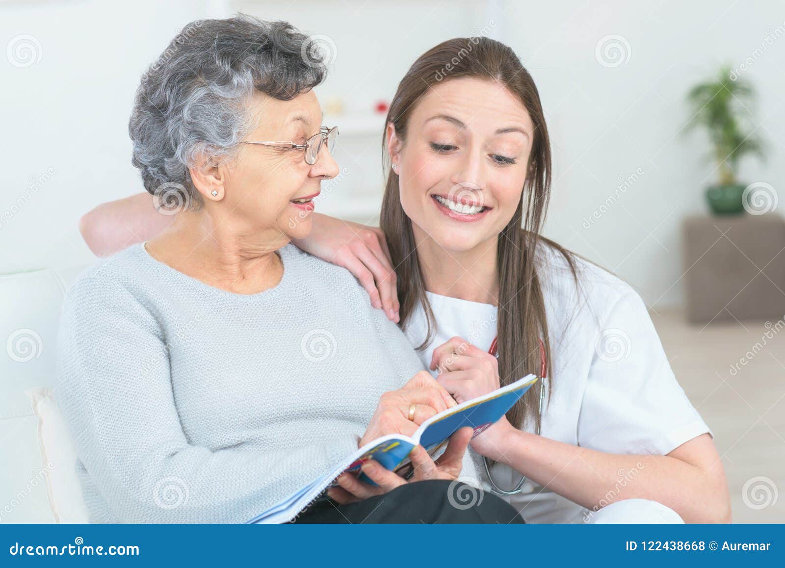 Helping old lady to read stock photo. Image of senior - 122438668