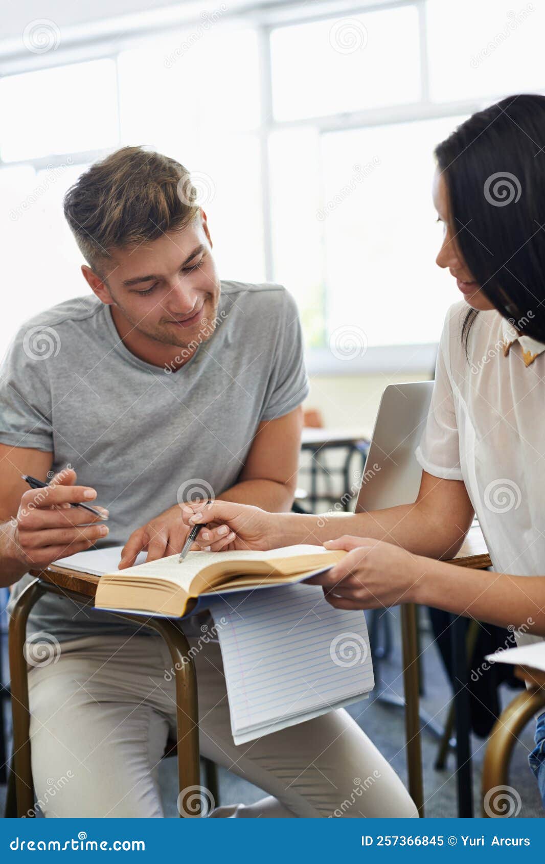 Helping Out a Classmate. Two Students Helping Each Other in a Varsity ...