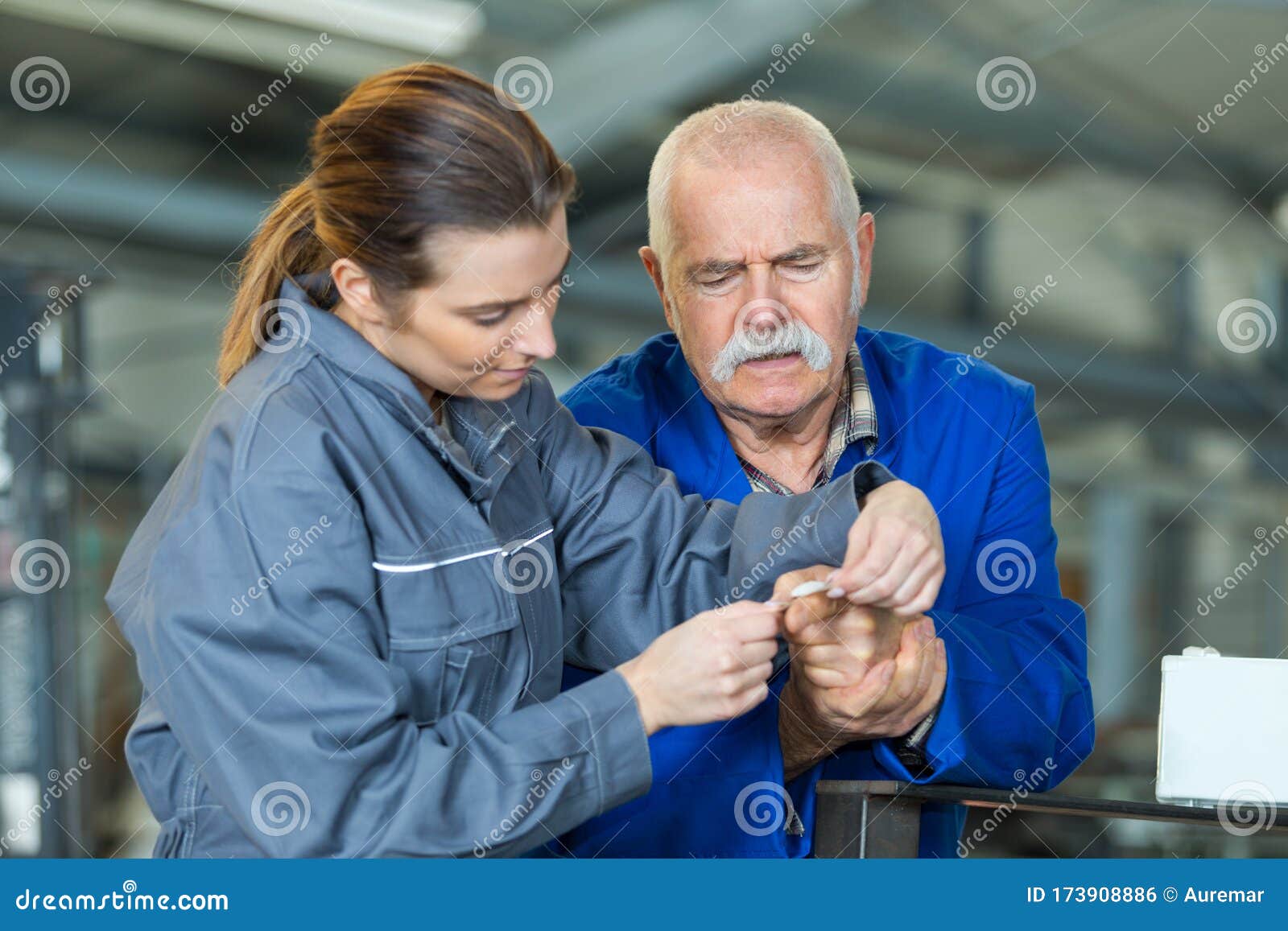 Helping Senior Colleague with Finger Accident Stock Photo - Image of ...