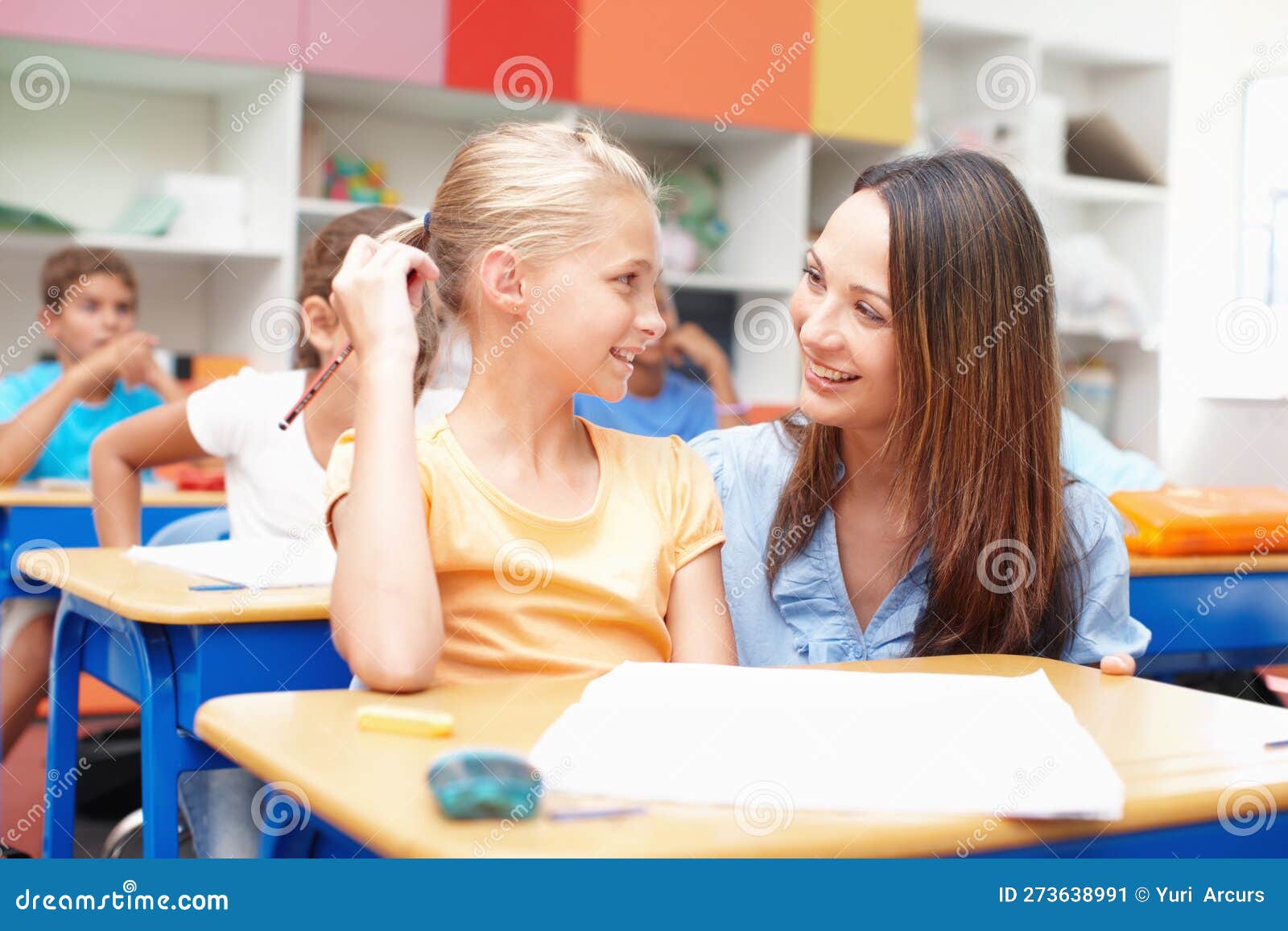Helping Students Individually. a Happy Young Teacher Helping a Student ...