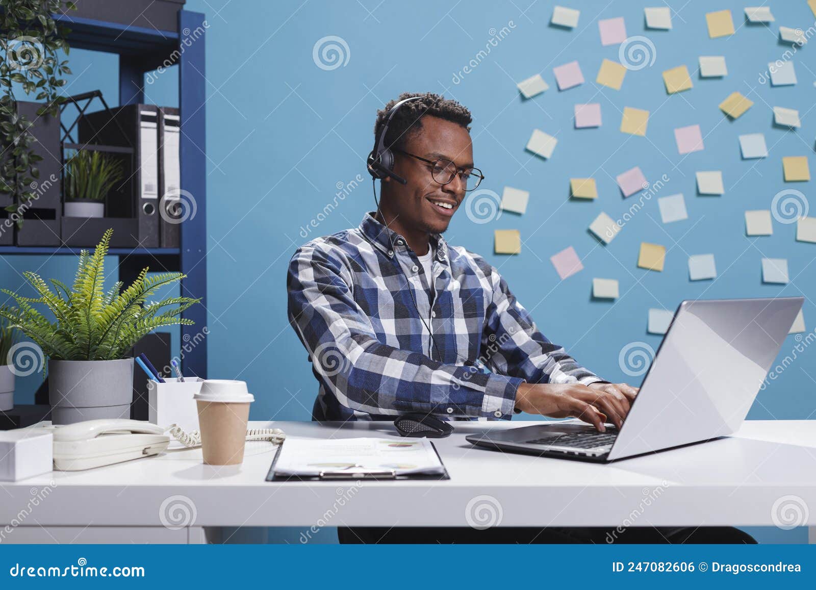 Helpline Support Agent Wearing Headset and Using Work Computer Stock ...